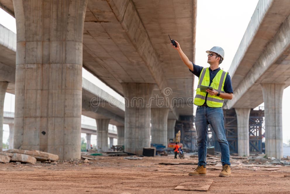 A Civil Engineer Standing Pointing at a Road or Expressway Construction ...