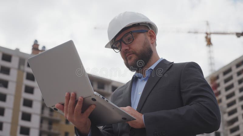 Civil Engineer in Suit and Protective Helmet Making Important Notes in ...