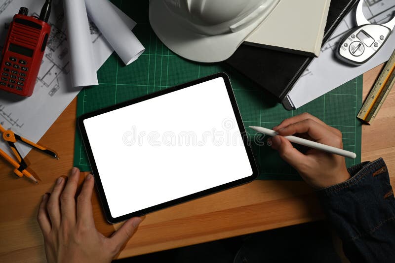 Civil Engineer Using Digital Tablet and Working with Blueprints at ...