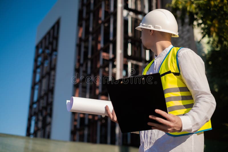 Civil Engineer Using a Tablet, Planning a Project, Builds a Modern ...