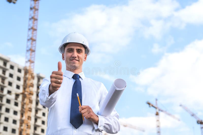 Civil Engineer in a White Helmet on the Background of Construction ...
