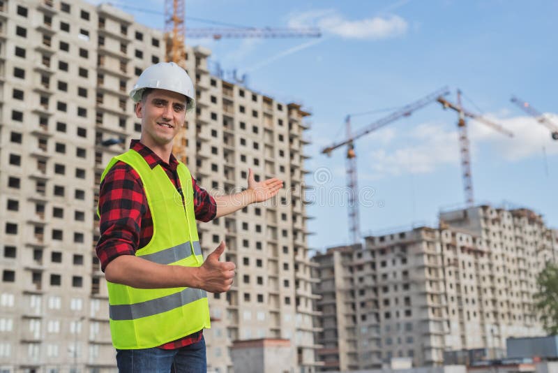 Civil Engineer in a White Helmet on the Background of Construction ...