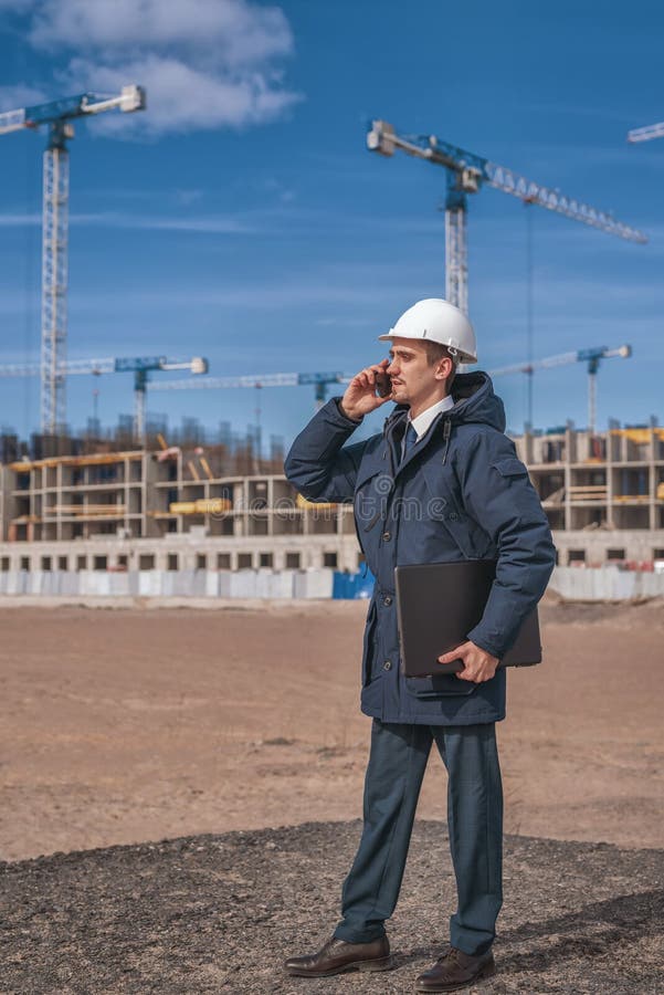 Civil Engineer in a White Helmet on the Background of a Building Under ...