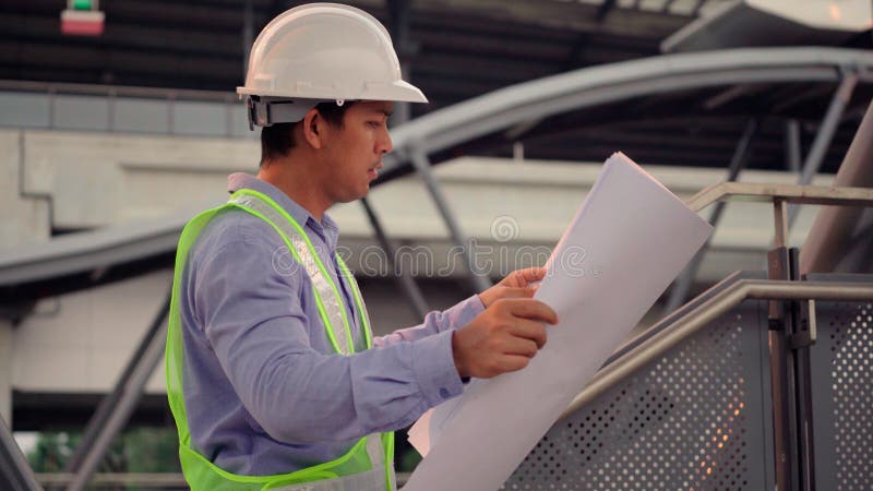 Civil Engineer Work Inspecting Architect Drawing on Construction Site ...