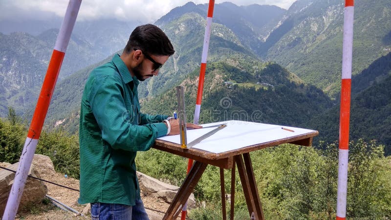 Civil Engineer Working on the Plane Table Doing Survey in the Hilly ...