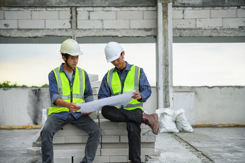 Civil Engineers Discuss with Foreman or Builder while Opening ...