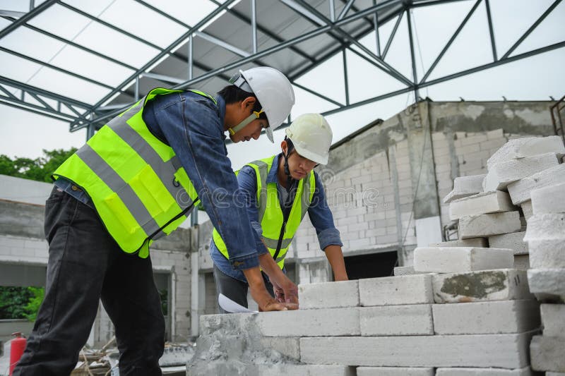 Civil Engineers Discuss with Foreman or Builder while Opening ...