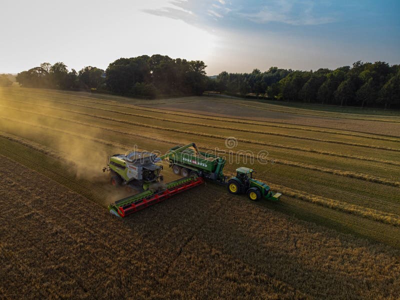 Claas 8900 Harvester Combine Offloading To Tractor Editorial Stock ...