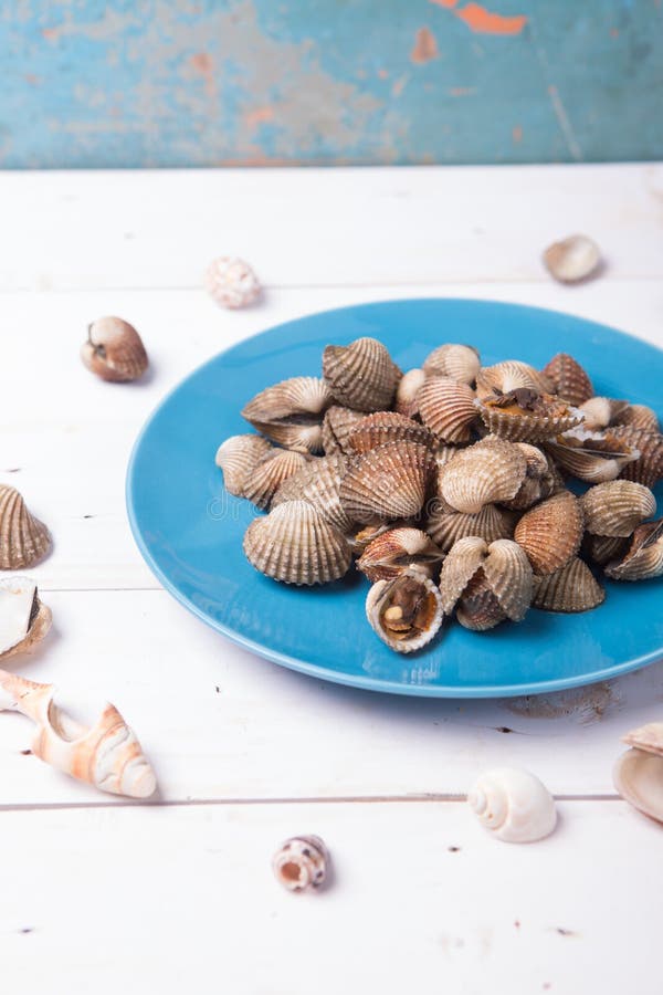 With Shell on a Blue Plate on a White Wood Background with Chilli and ...