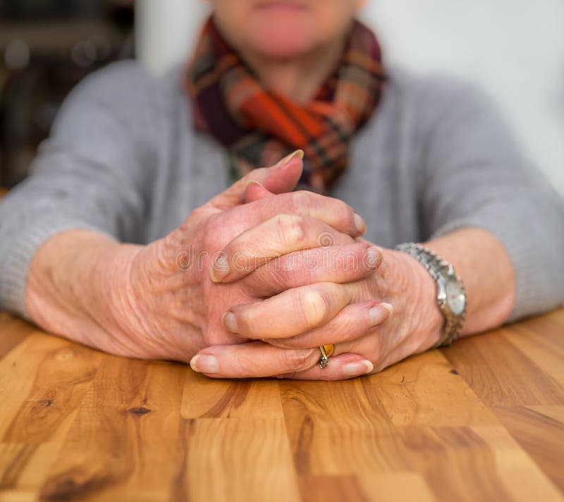 Clasped Hands of an Elderly Lady Sitting at a Table. Stock Photo ...
