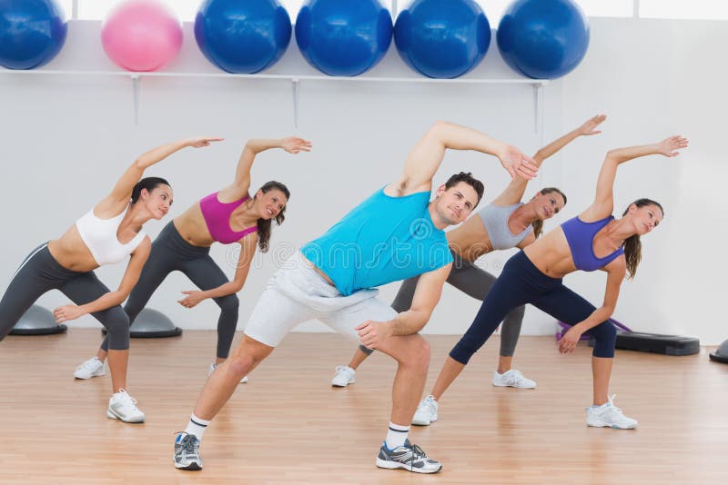 Class Doing Stretching Exercise in Fitness Studio Stock Image - Image ...