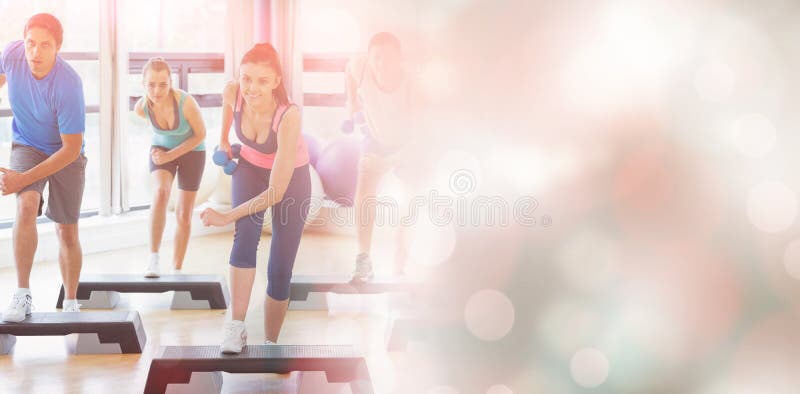 Class Performing Step Aerobics Exercise with Dumbbells Stock Photo ...