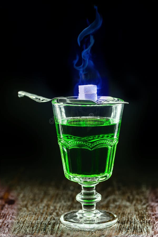 Classic Absinthe Cup with Metal Spoon and Sugar Melting in Blue Flame ...