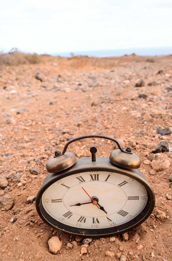 Classic Analog Clock in the Sand Stock Photo - Image of horizon, clock ...