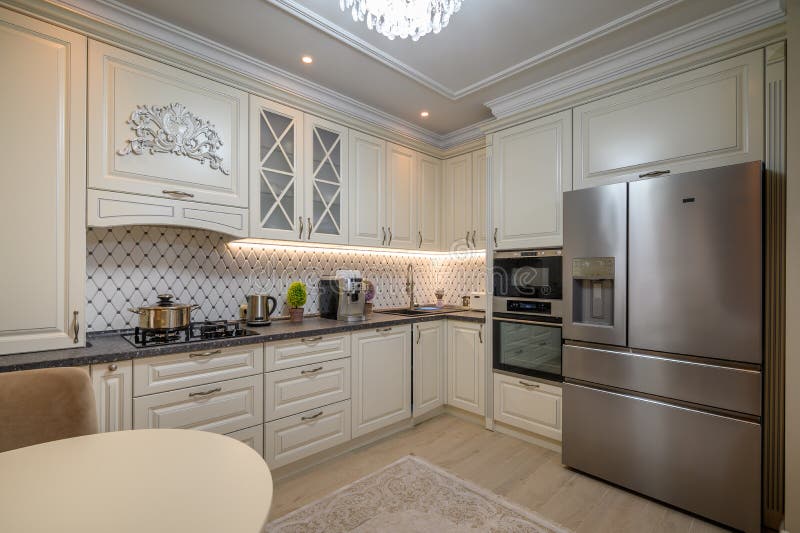 Classic Beige Kitchen with Counter Space and a Variety of Appliances ...