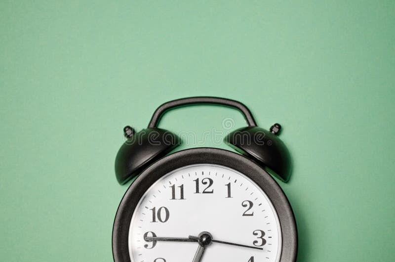 Classic Black Alarm Clock on the Green Bed Sheets Stock Image - Image ...