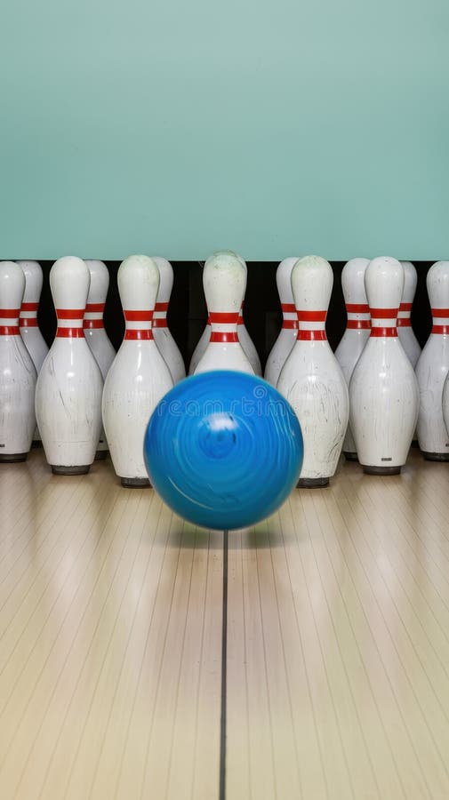 Classic Bowling Alley with Blue Bowling Ball and Lined-Up Pins Stock ...