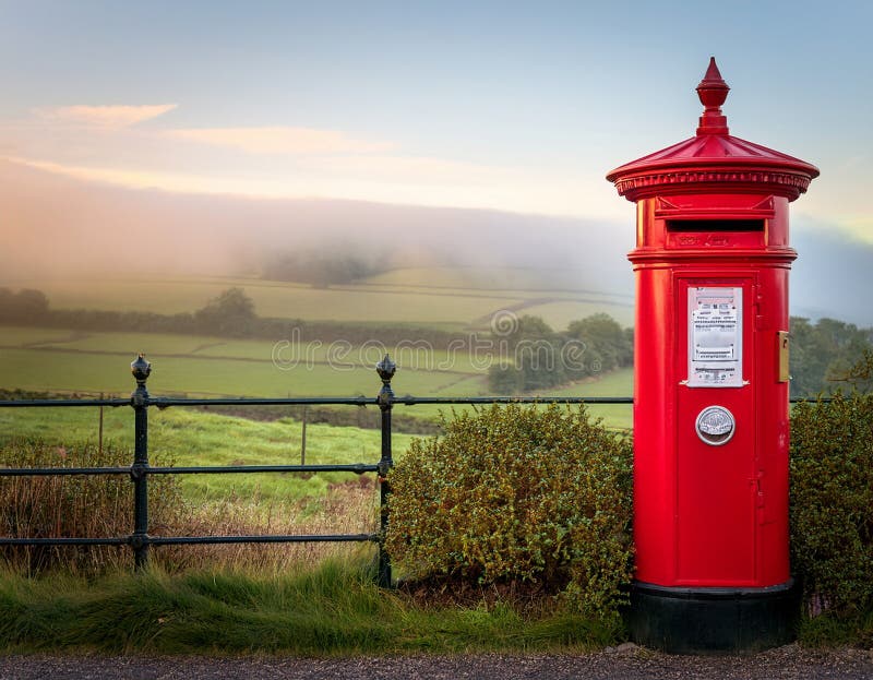 Classic British Red Post Box with a Misty Countryside Backdrop Stock ...
