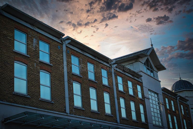 Classic Building Facade Against a Dramatic Sunset Sky with Clouds Stock ...