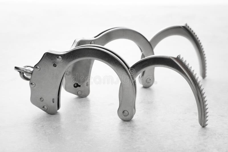 Classic Chain Handcuffs on Light Grey Table, Closeup Stock Photo ...