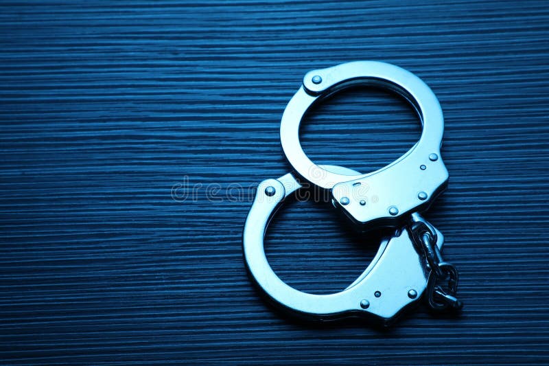 Classic Chain Handcuffs on Table, Closeup. Space for Text Stock Photo ...
