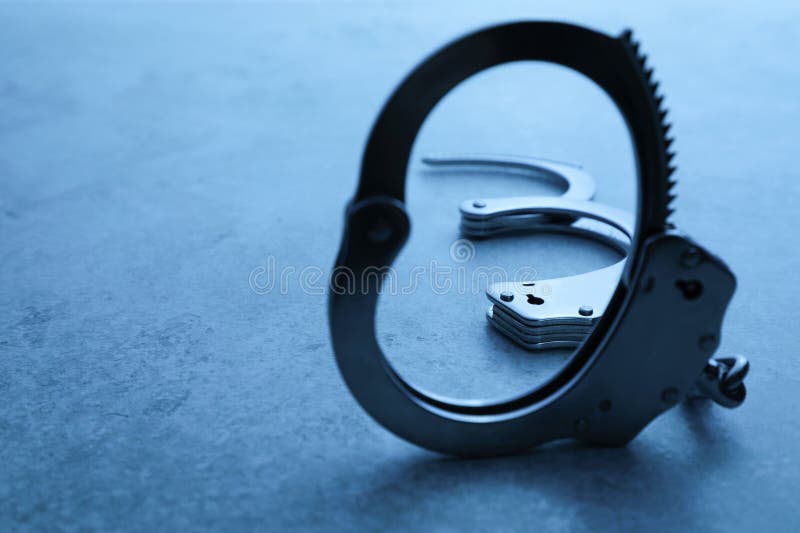 Classic Chain Handcuffs on Table, Space for Text. Color Toned Stock ...