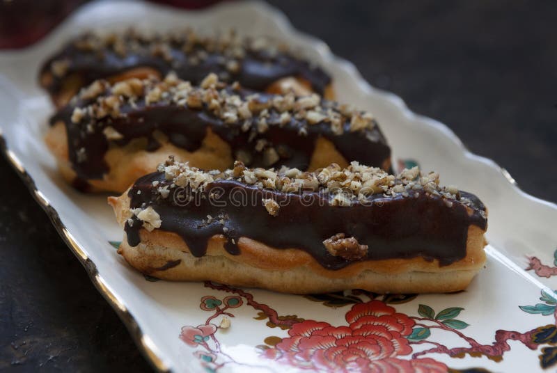 Classic Chocolate Eclair with Custard Cream and Chopped Walnuts on Top ...