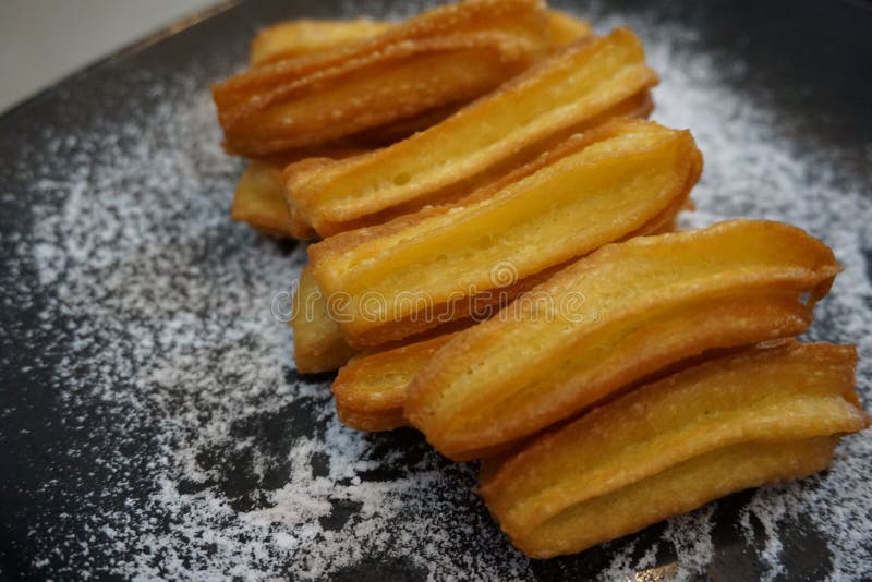 Classic Churros with Ice Sugar on Black Plate Stock Photo - Image of ...