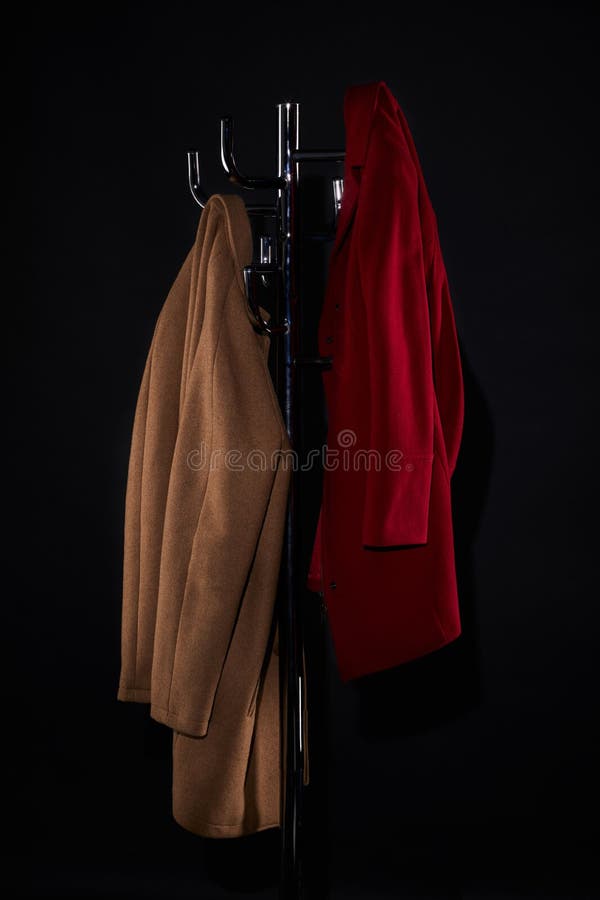 Classic Coats on Coat Rack on Black Stock Photo - Image of black ...