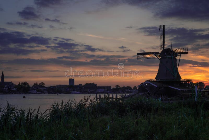 Classic Dutch Windmill at Sunset Stock Photo - Image of horizon, lake ...