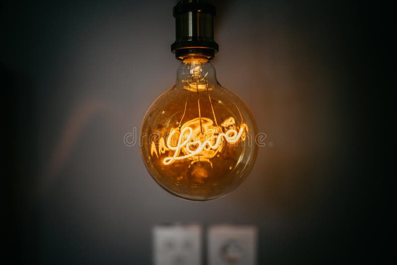 A Classic Edison Light Bulb on Black Background with Space for Text ...