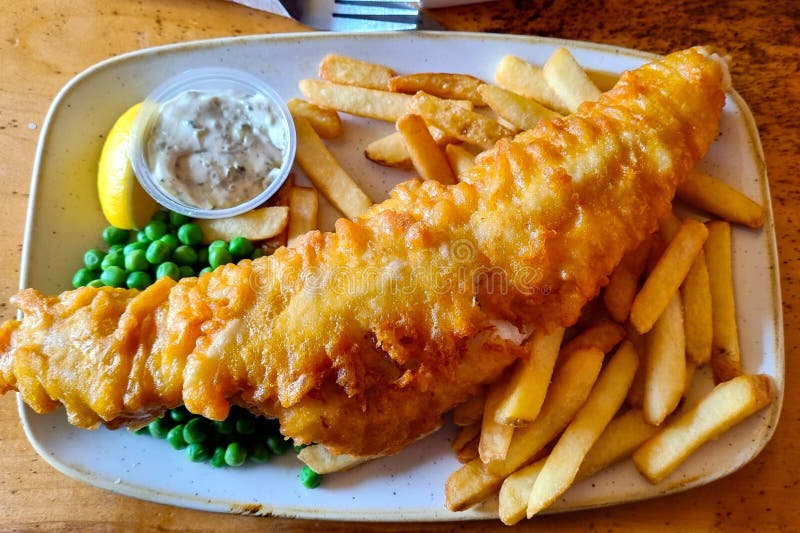 Classic Fish and Chips with Peas and Tartar Sauce on Rustic Plate Stock ...