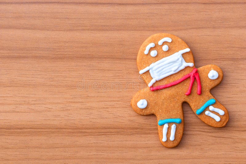 Classic Gingerbread Cookies Man with a Medical Mask on the Table. a ...