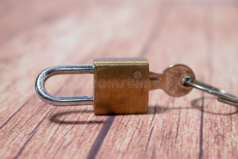 Classic Golden Bronze Padlock with Keys on a Wooden Background. Concept ...