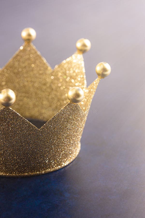 Classic Golden Crown on a Blue Table with Light Streaming in Stock ...