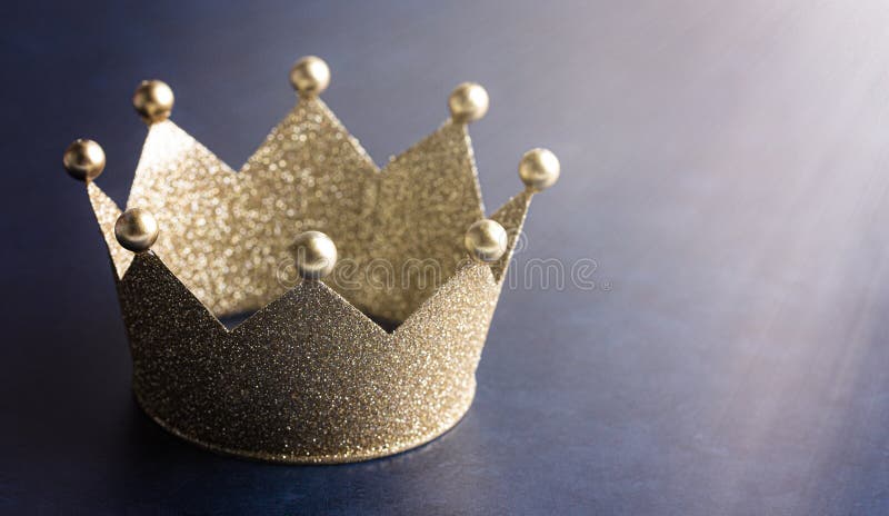 Classic Golden Crown on a Blue Table with Light Streaming in Stock ...