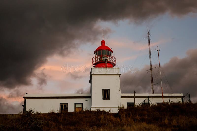 The Classic Lighthouse with Red Head during the Sunset, Dramatic Clouds ...