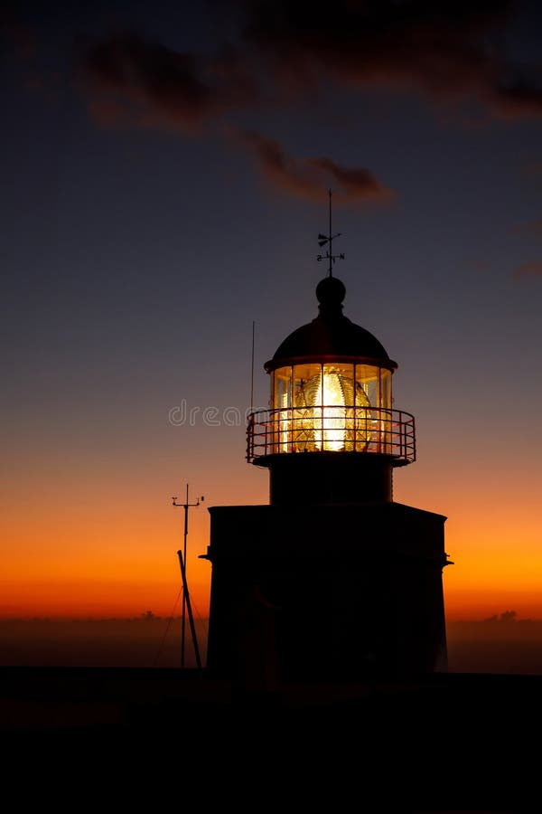 The Classic Lighthouse Silhouette during the Sunset, Dramatic Clouds in ...