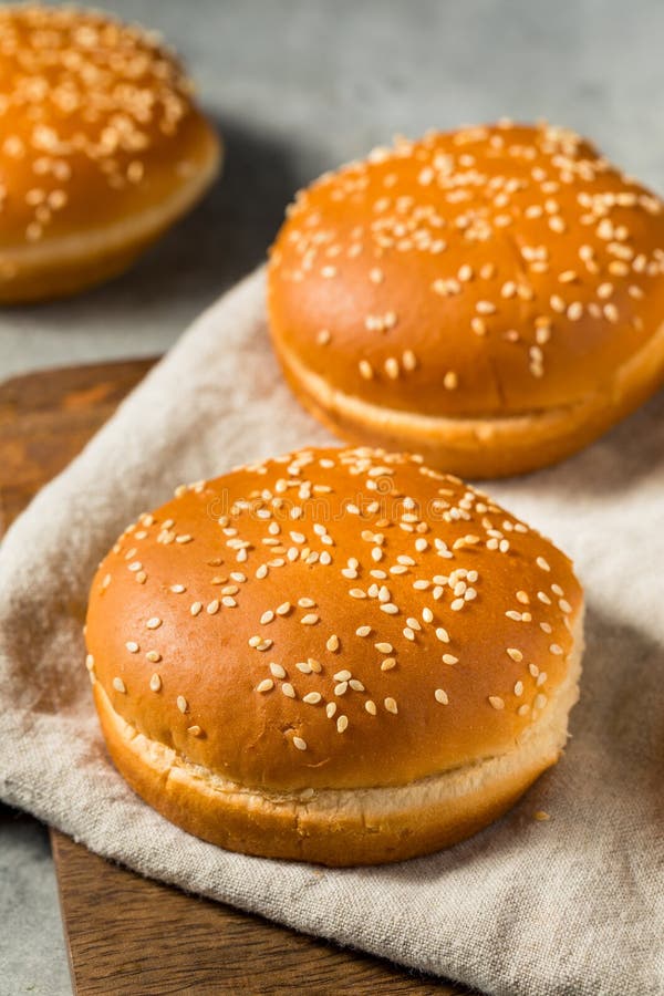 Classic Sesame Seed Hamburger Buns on a Wooden Board, Top View Stock ...