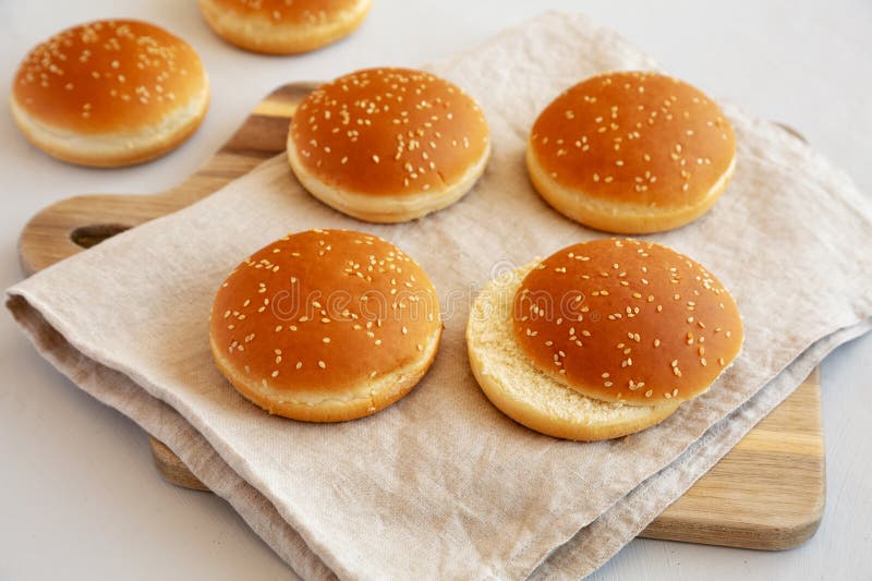 Classic Sesame Seed Hamburger Buns on a Wooden Board, Side View Stock ...