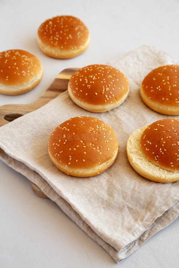 Classic Sesame Seed Hamburger Buns on a Wooden Board, Side View Stock ...
