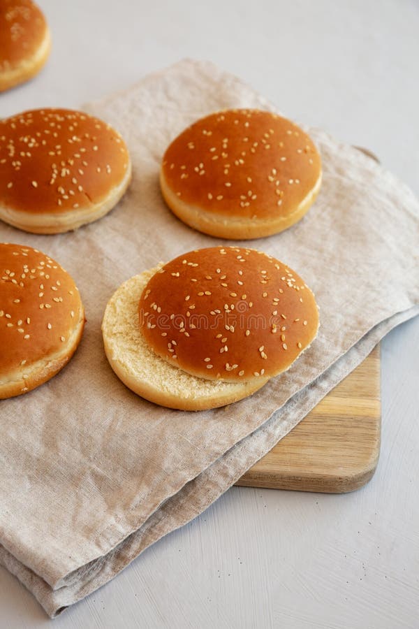 Classic Sesame Seed Hamburger Buns on a Wooden Board, Side View Stock ...