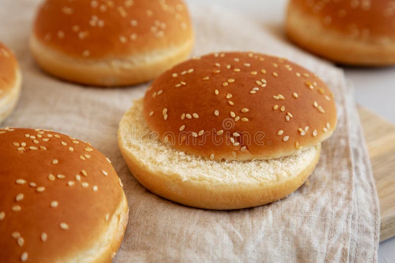 Classic Sesame Seed Hamburger Buns on a Wooden Board, Side View Stock ...