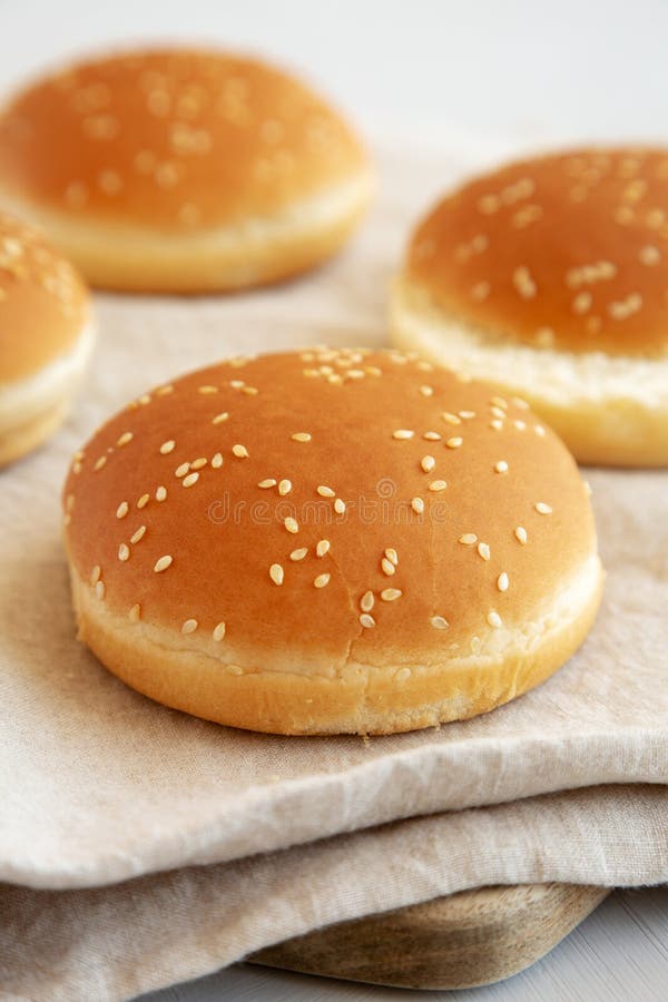 Classic Sesame Seed Hamburger Buns on a Wooden Board, Side View Stock ...