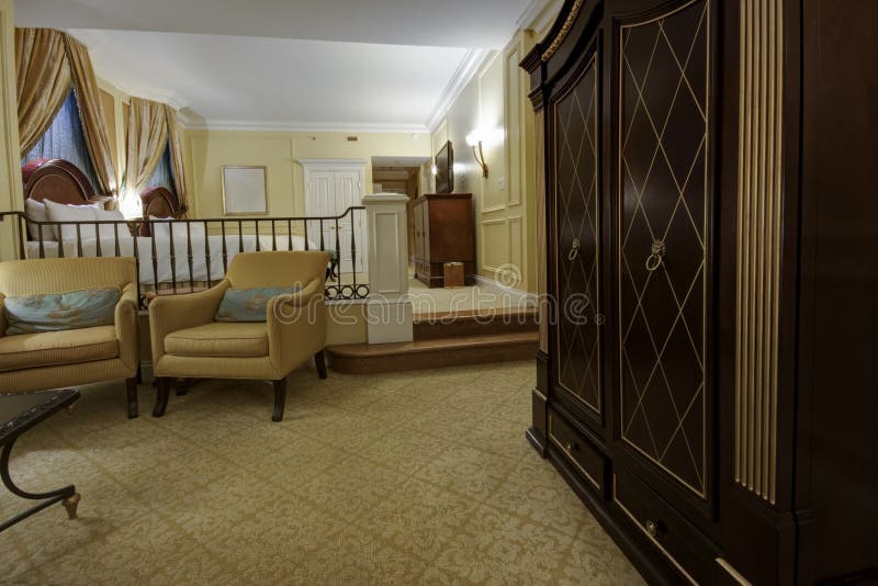 Classic Two Level Room with Armchairs, TV Set and Bed Stock Image ...