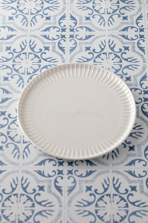 Classic White Ceramic Plate on a Beautifully Patterned Blue and White ...