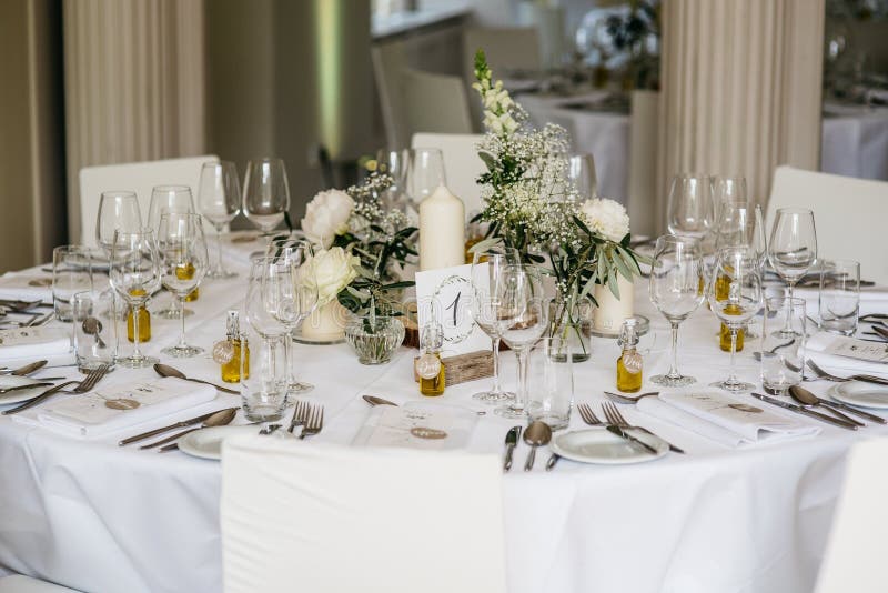 A Table Set with a Table Number, Wine Glasses and Silverware Stock ...