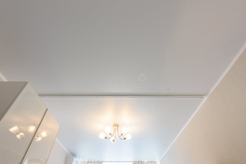 Classic White Matte Stretch Ceiling with Five Lamp Chandelier in the ...