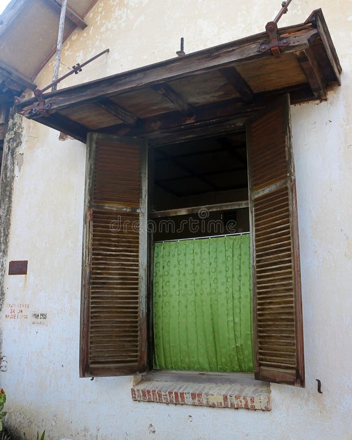 A Classic Wooden Window with a Canopy and Green Curtains Stock Photo ...