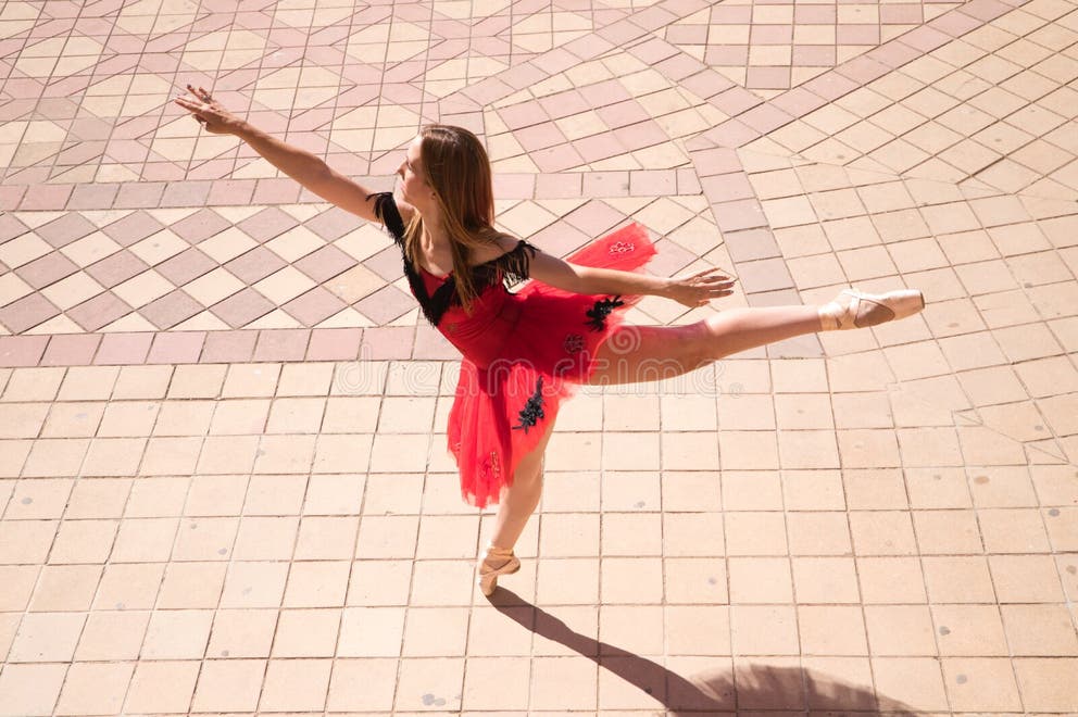 Classical Ballet Dancer Dancing in the Street. the Dancer is Wearing a ...